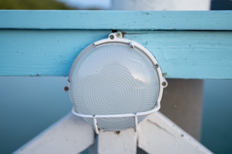 White Lamp on a Wooden Railing by the Water Stock Image - Image of ...