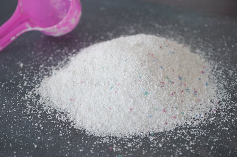 White Laundry Detergent Powder with a Pink Scoop on a Dark Surface ...