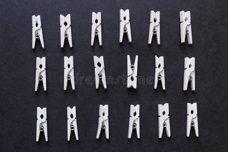 White Laundry Pins on Black Surface Background Stock Photo - Image of ...