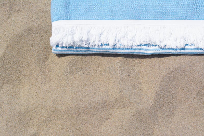 White and Light Blue Striped Towel on Sandy Beach, Top View. Space for ...