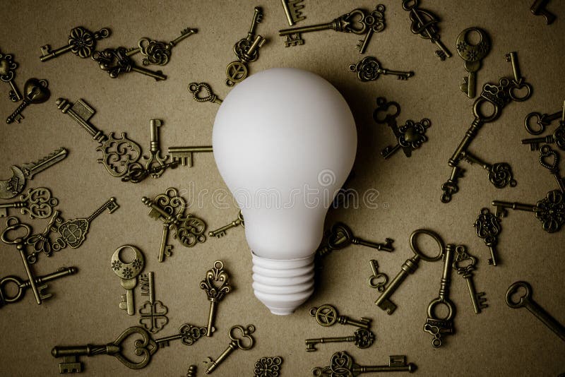 White Light Bulb and Many Keys on Brown Paper. Stock Image - Image of ...