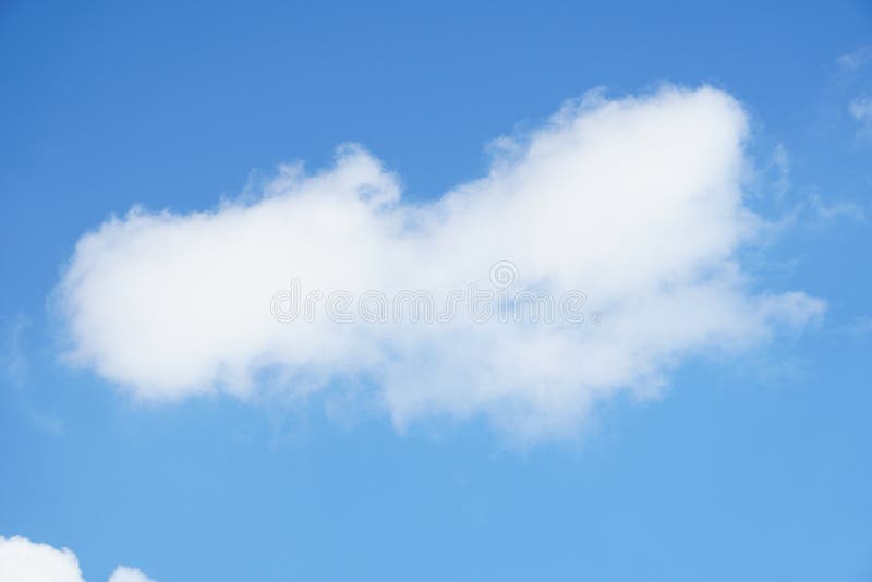 White Light Fluffy Clouds in a Blue Sky with a Solar Flare Stock Photo ...
