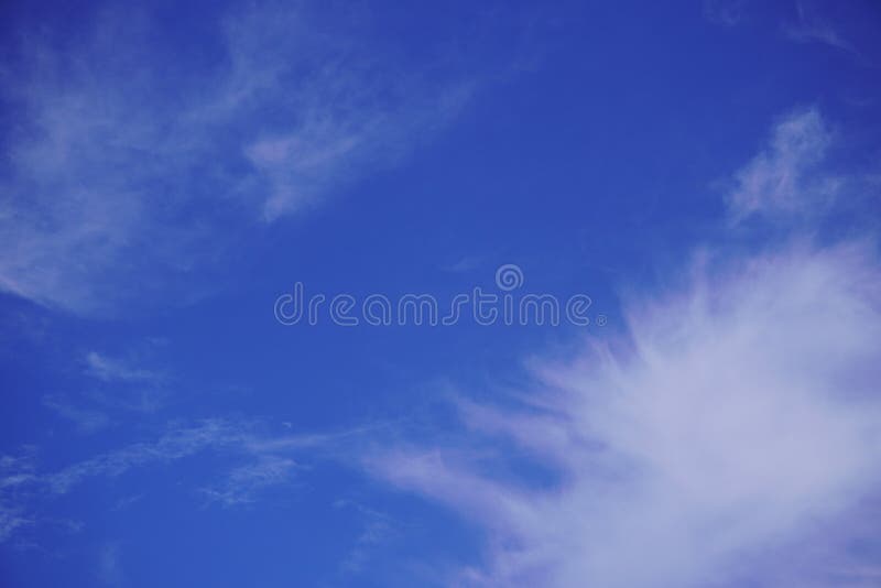 White Light Fluffy Clouds in a Blue Sky with a Solar Flare Stock Image ...