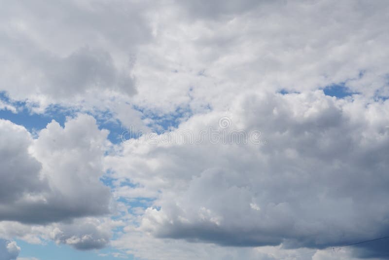 White Light Fluffy Clouds in a Blue Sky with a Solar Flare. Stock Photo ...