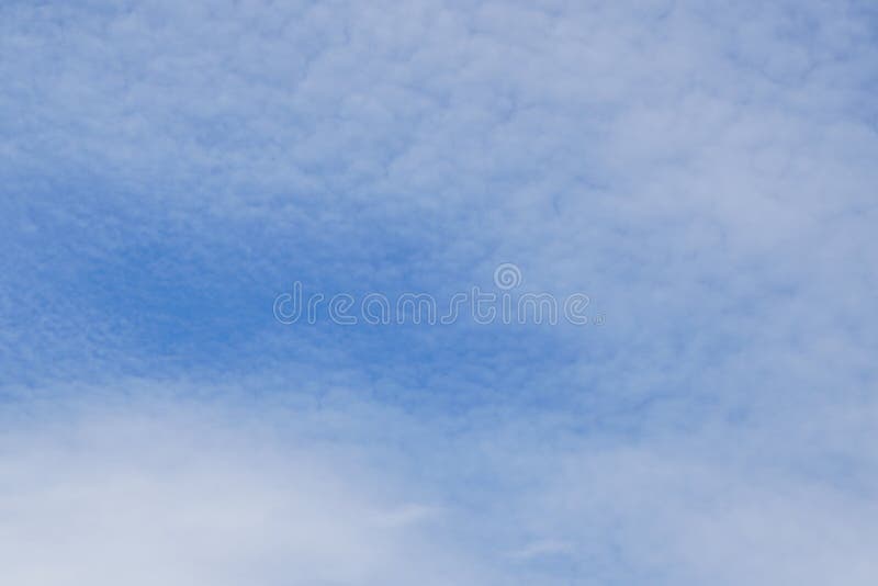 White Light Fluffy Clouds in a Blue Sky with a Solar Flare. Stock Image ...