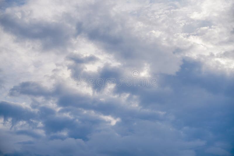 White Light Fluffy Clouds in a Blue Sky with a Solar Flare. Stock Photo ...