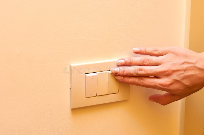 White Light Switch with Hand on the Wall in the Room Stock Photo ...