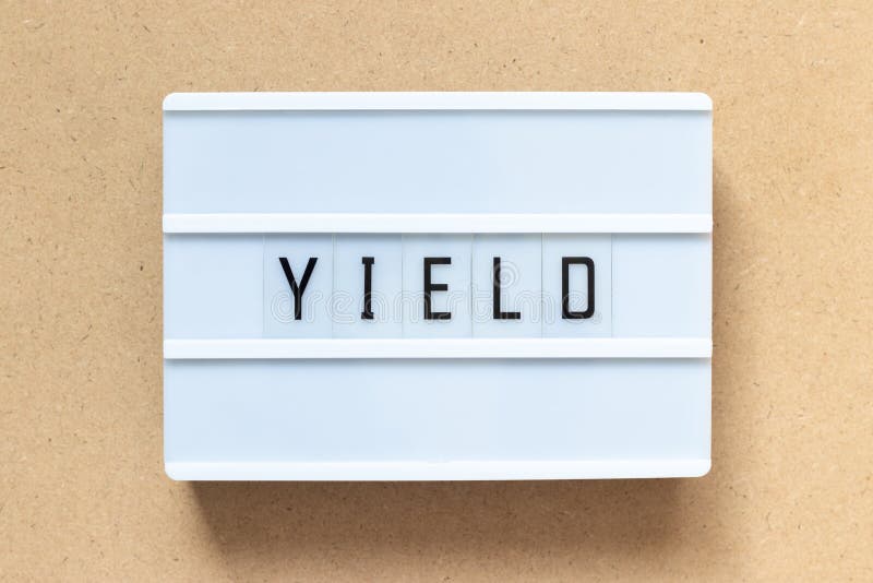 White Light Box with Word Yield on Wood Background Stock Image - Image ...