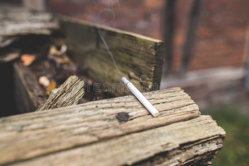 White Lighted Single Cigarette Stick On Beige Wood Picture. Image: 83063474