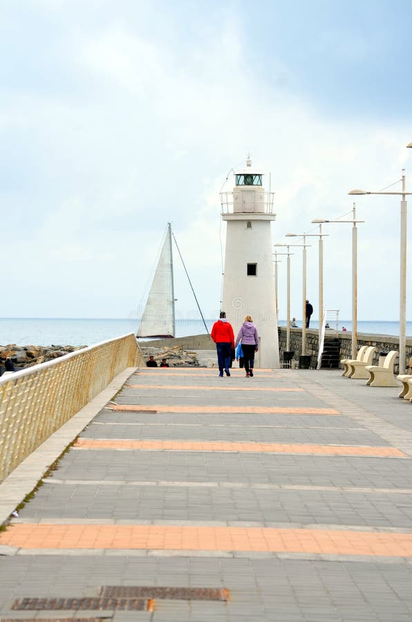 White Lighthouse at the Bottom of the Road Stock Photo - Image of ...