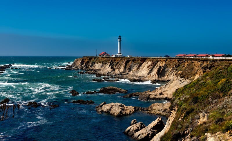 White Lighthouse Near Body Of Water Under Blue Sky During Daytime Stock ...