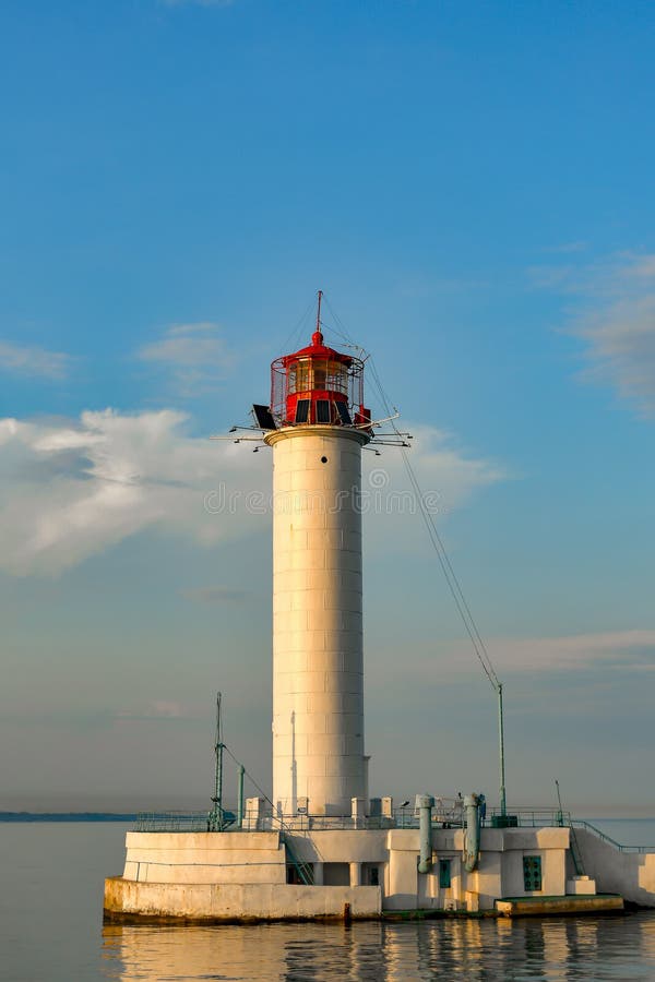 White Lighthouse with a Red Tower in the Seaport Stock Photo - Image of ...