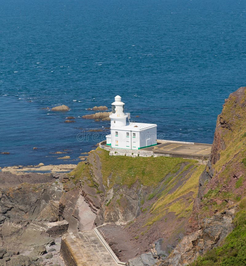 White Lighthouse on rocks stock photo. Image of design - 32622216