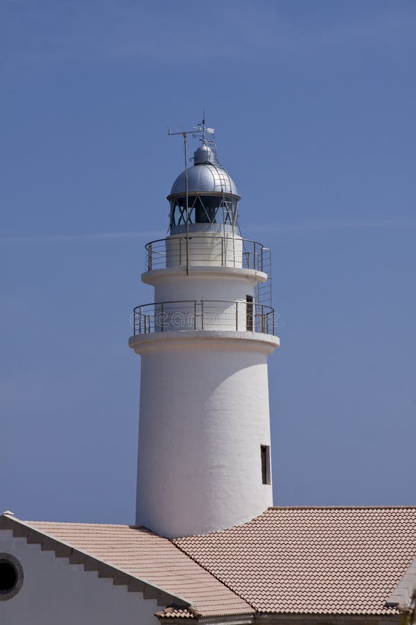 White Lighthouse on Rocks in the Sea Ocean Water Sky Blue Stock Image ...