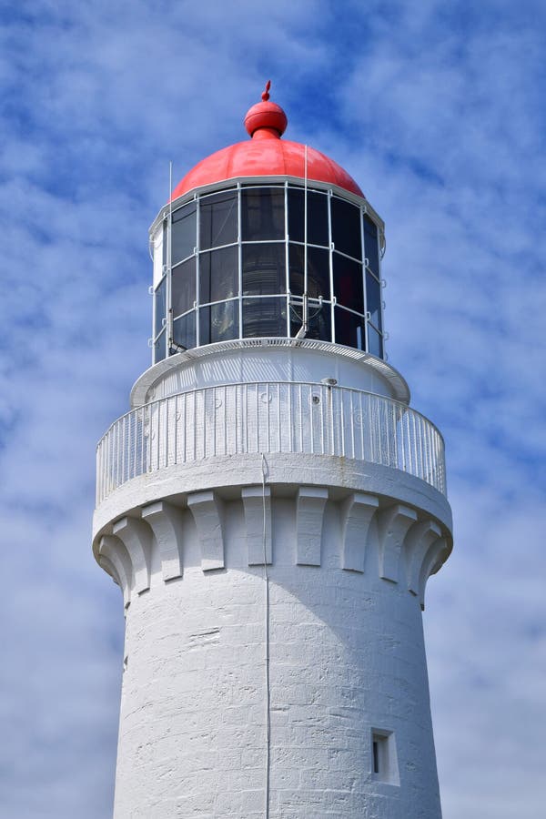 White Lighthouse Tower on the Coast with the Clouds in the Background ...