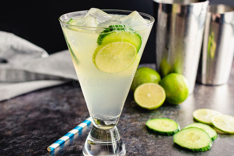 White Linen Cocktail with Cucumber and Lime Garnish Stock Photo - Image ...