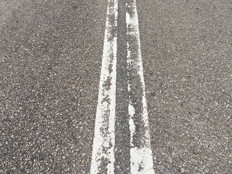 White Lines on a Tarmac Road Stock Image - Image of white, worn: 243167977