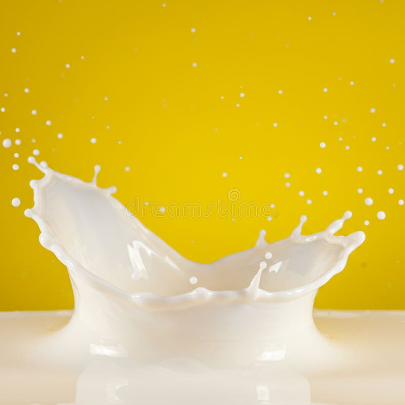 White Liquid Splash Captured Mid-air Against a Vibrant Yellow ...