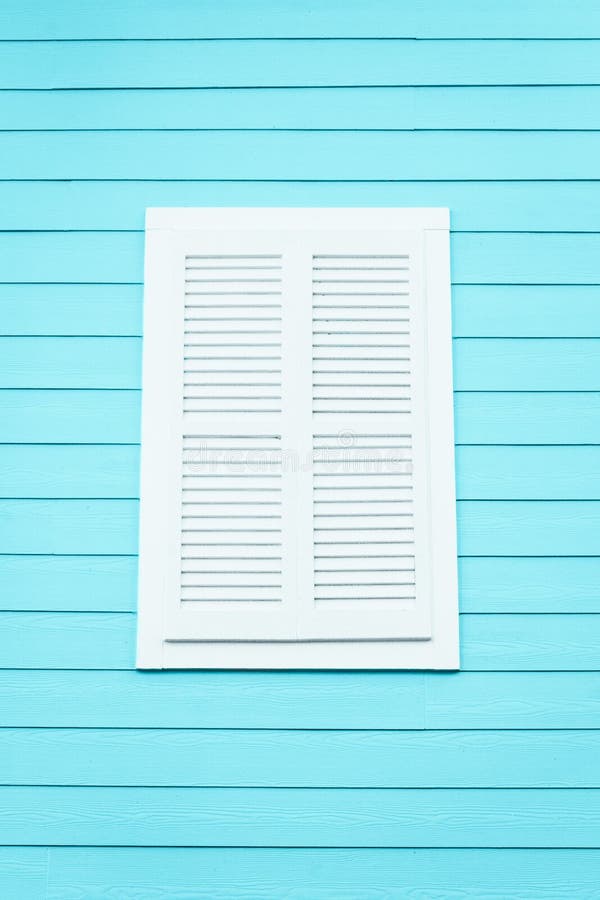 White Louvered Window Shutter on a Pink Wooden Building Stock Photo ...
