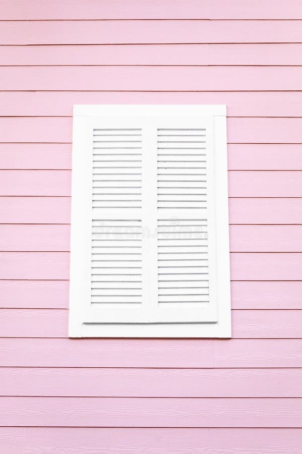 White Louvered Window Shutter on a Pink Wooden Building Stock Photo ...