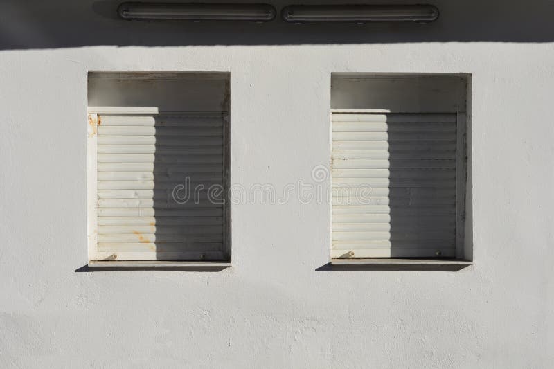 With White Lowered Blinds on a White Wall, with a Strong Contrast of ...