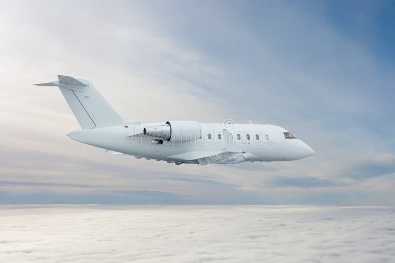 White Luxury Business Jet Flying in the Air Above the Clouds Stock ...