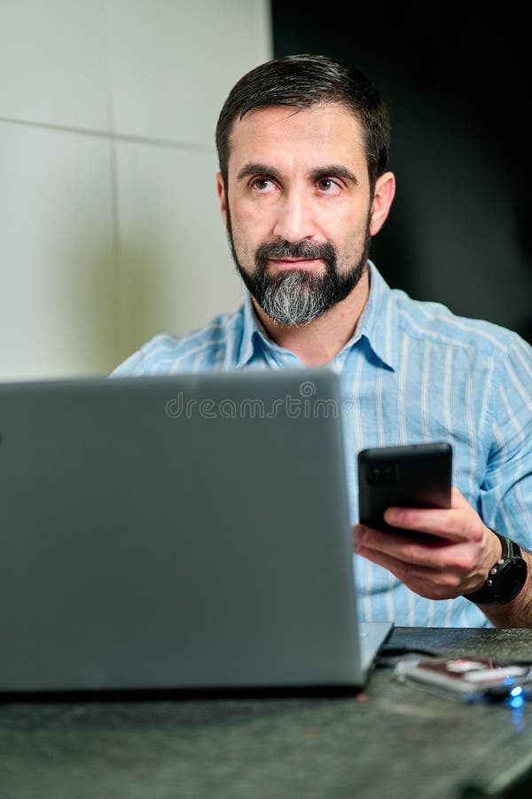 White Man with Beard Working on Laptop and Looking Up Stock Photo ...