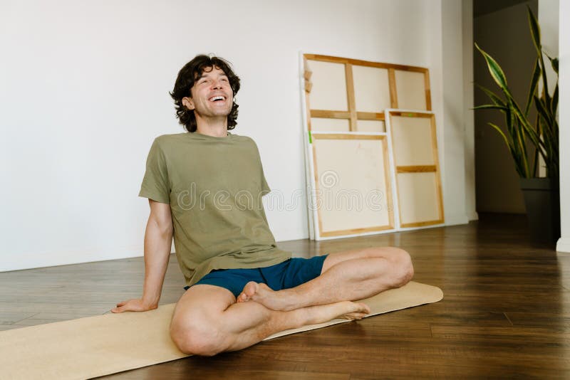 White Man Laughing and Sitting on Mat during Yoga Practice Stock Image ...