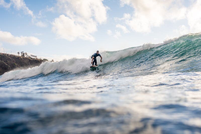 White Man Surfing on Beach Waves Against the Bright Sky Stock Photo ...