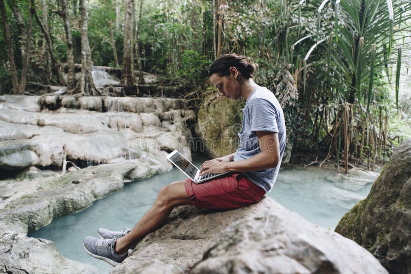 White Man Using Computer Laptop at Waterfall Stock Image - Image of ...