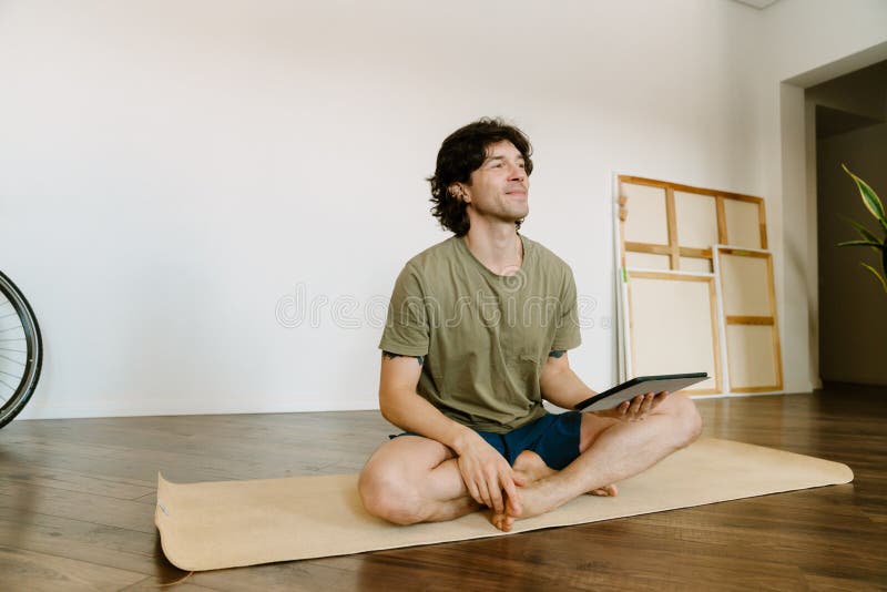 White Man Using Tablet Computer during Yoga Practice Stock Photo ...