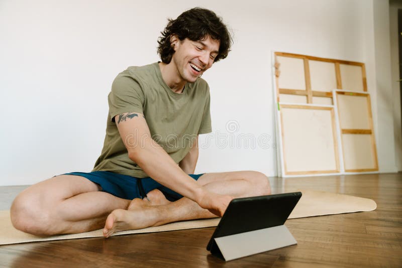 White Man Using Tablet Computer during Yoga Practice Stock Photo ...