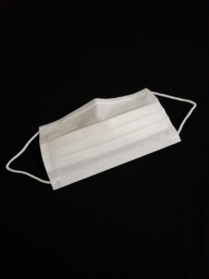 White Mask on Black Background Stock Photo - Image of textile ...