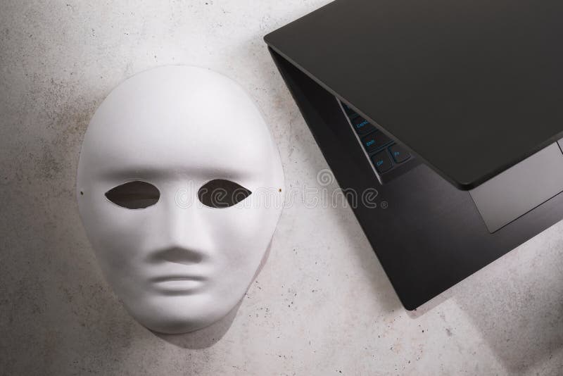 White Mask and Laptop on the Table, Top View, Internet Anonymity ...
