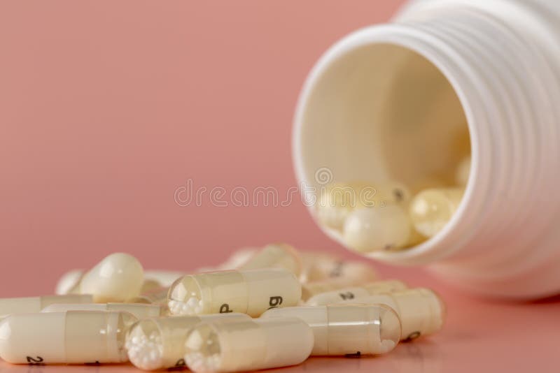 Medicinal Bottle and Scattered Transparent Capsules with Microgranules ...