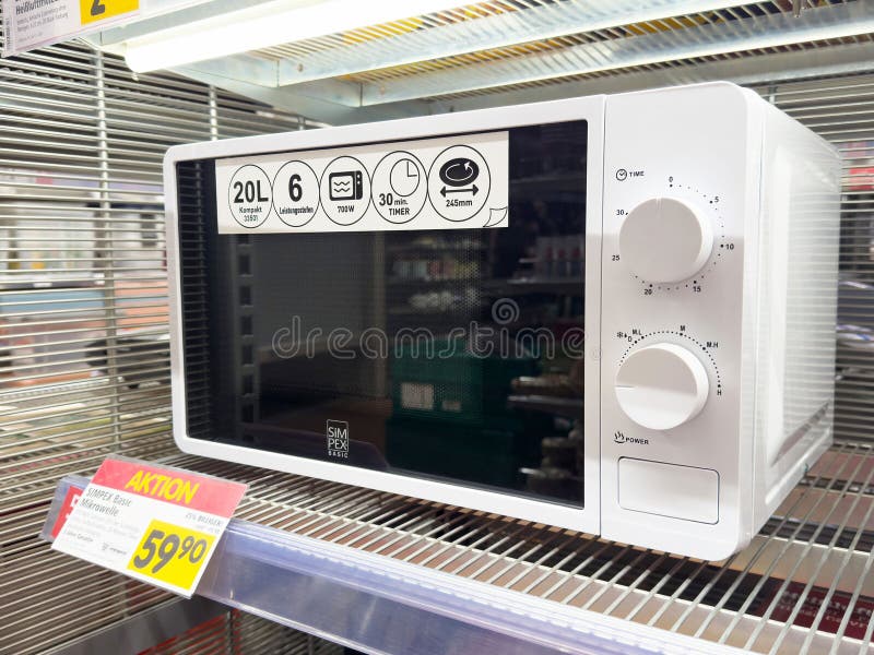 White Microwave Oven on Store Shelf with Control Knobs and Features ...