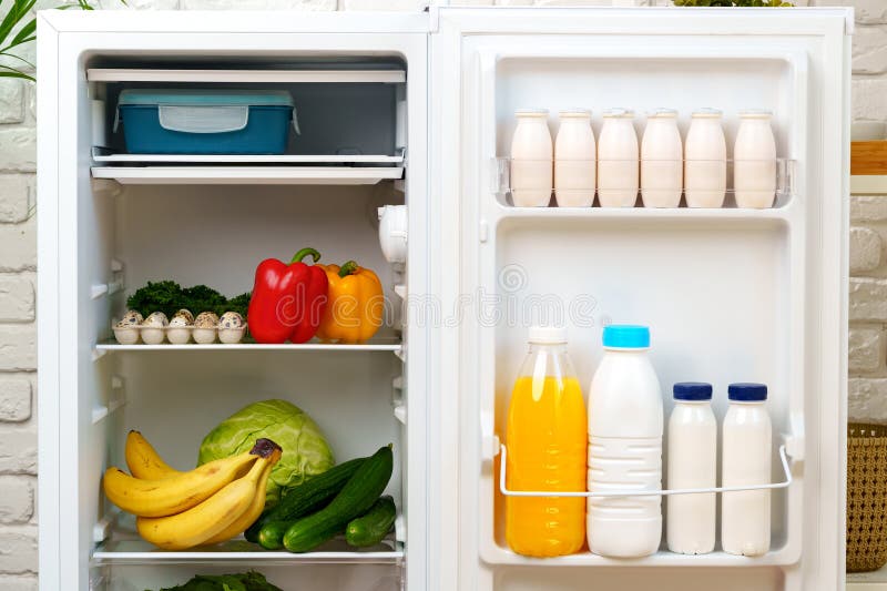 White Milk Bottles Stored in a Refrigerator Door Shelf Stock Image ...