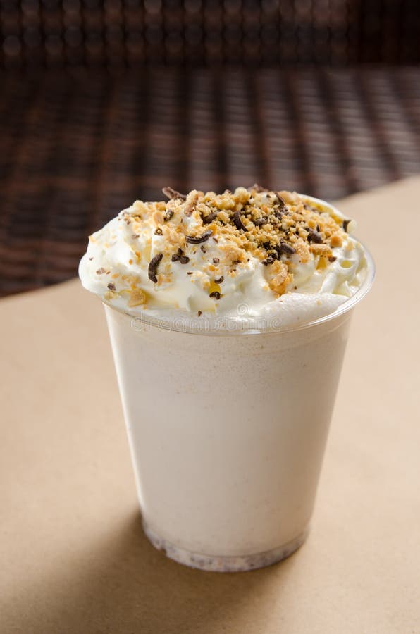 White Milkshake with Ice Cream Garnished with Chocolate and Nut Crumbs ...