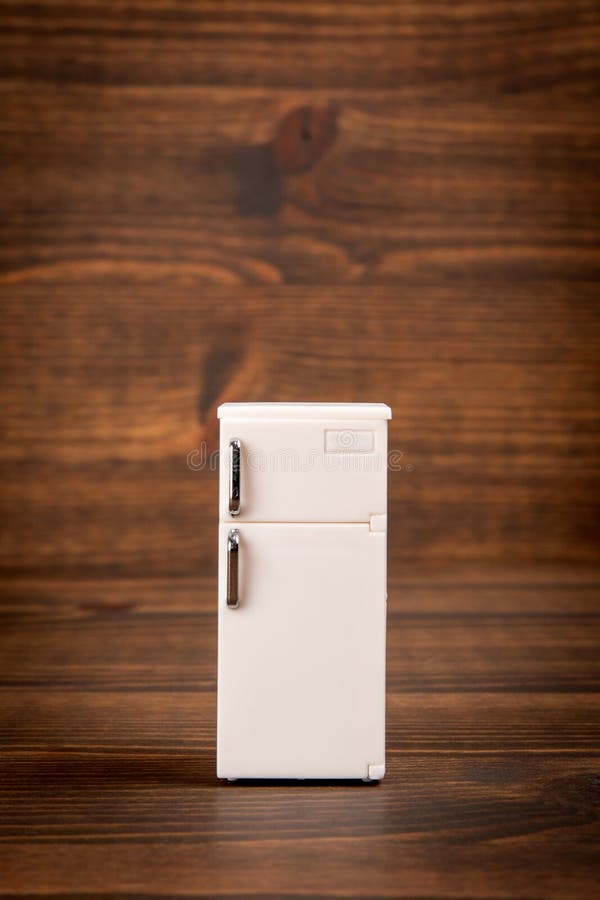 White Miniature Refrigerator on Wooden Texture Background Stock Image ...