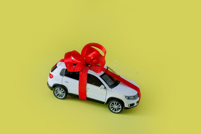 White Model Car with Bow on a Yellow Background. Car As Gift, Surprise ...