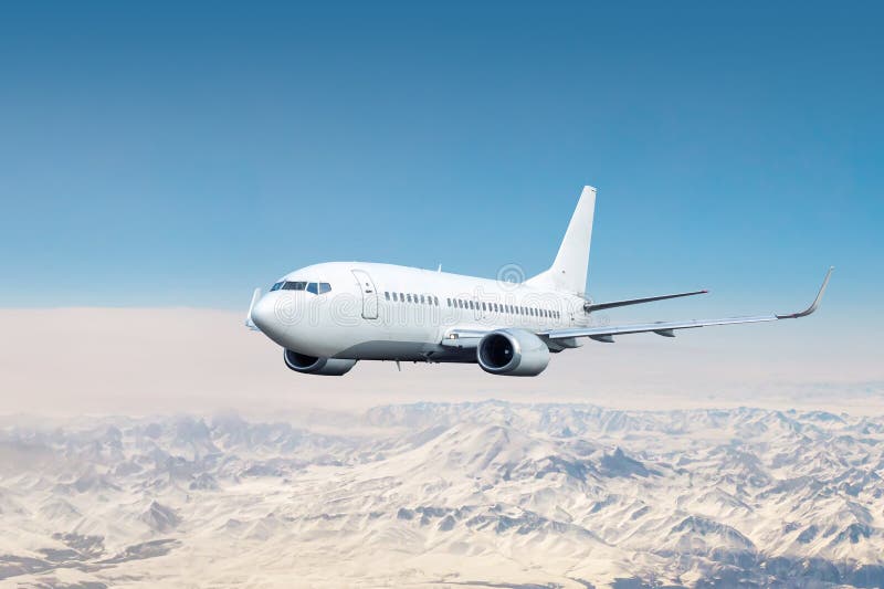 White Modern Jetliner Flying Over Snow Covered Mountains Stock ...