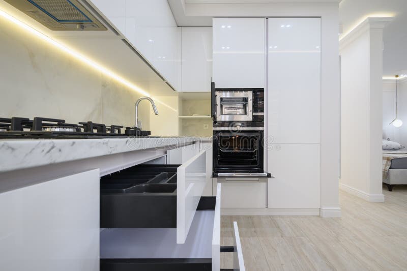 White Modern Kitchen with a Stove, Oven and Microwave, Drawers Pulled ...
