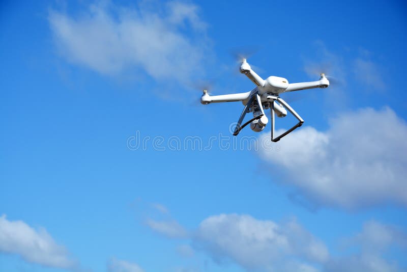 White Modern Drone with Camera Flying on Sky Background Stock Photo ...