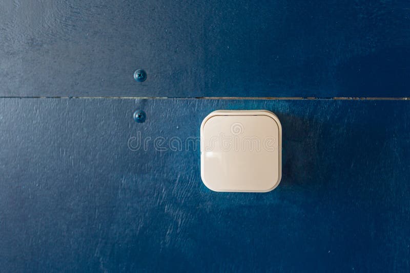 White Modern Plastic Light Switch on a Blue Wall Stock Image - Image of ...