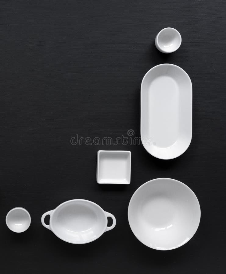 White, Modern Tableware in Various Designs on a Black Background Stock ...