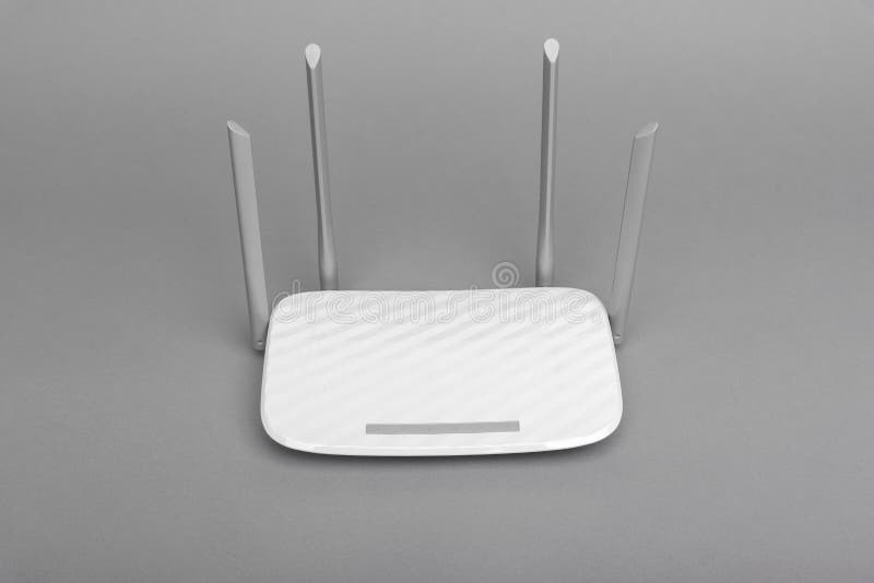 White Modern Wi-Fi Router with Four Antennas on Gray Background. Stock ...