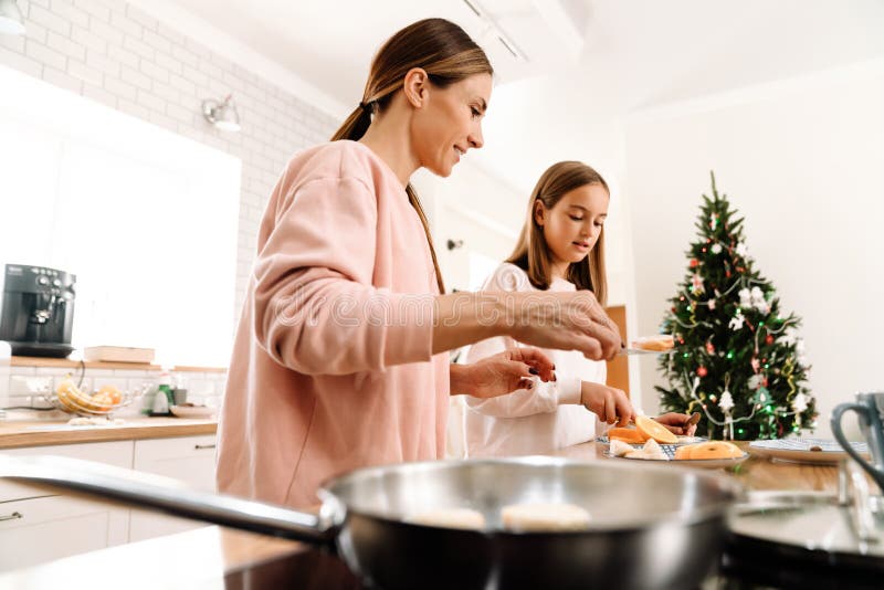 White Mother and Daughter Cooking Together in Kitchen Stock Photo ...