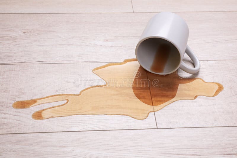 White Mug with Spilled Liquid on Wooden Floor Stock Photo - Image of ...