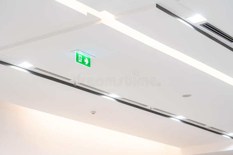 White Neon Sign Depicting a Fire Exit with Green Background Hangs from ...