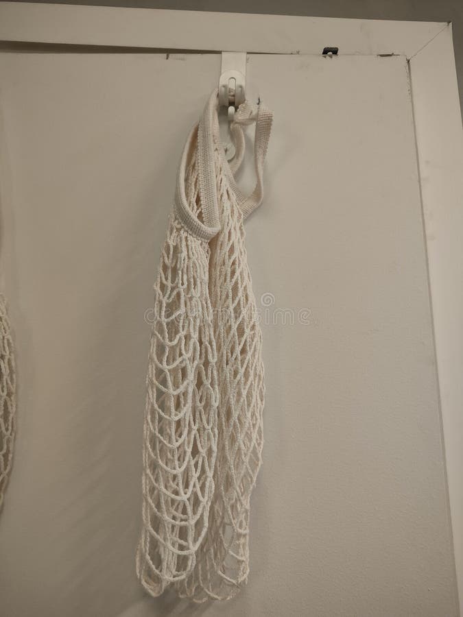 A White Net Bag Hanging on the Wall, with No Background and White Walls ...